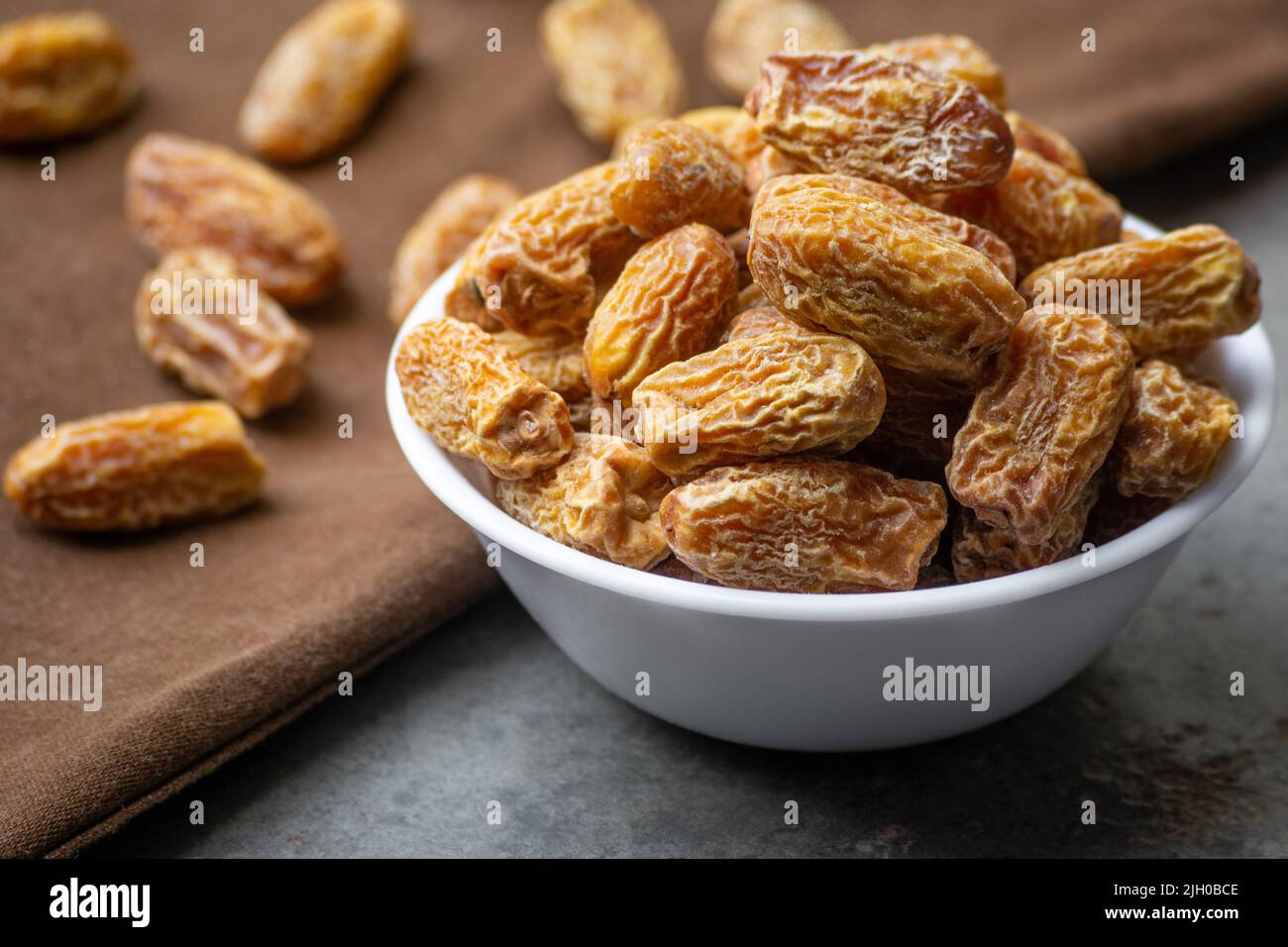 Indian dry dates in white bowl Stock Photo - Alamy