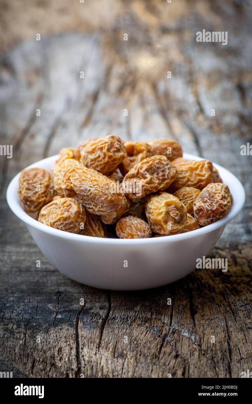 Indian dry dates in white bowl Stock Photo - Alamy