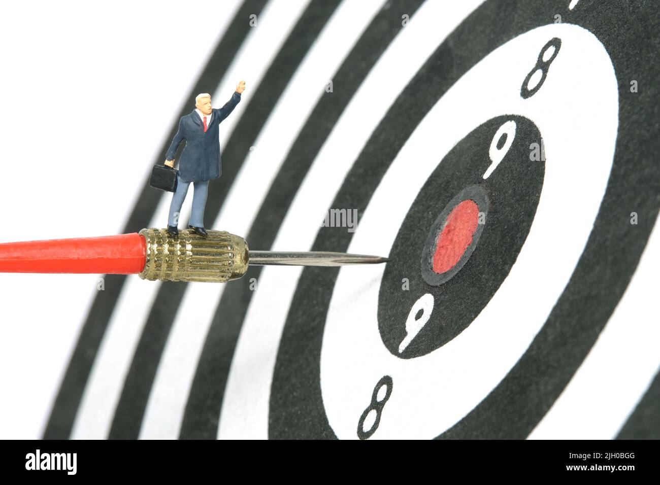 Miniature people toy figure photography. A businessman standing above ...