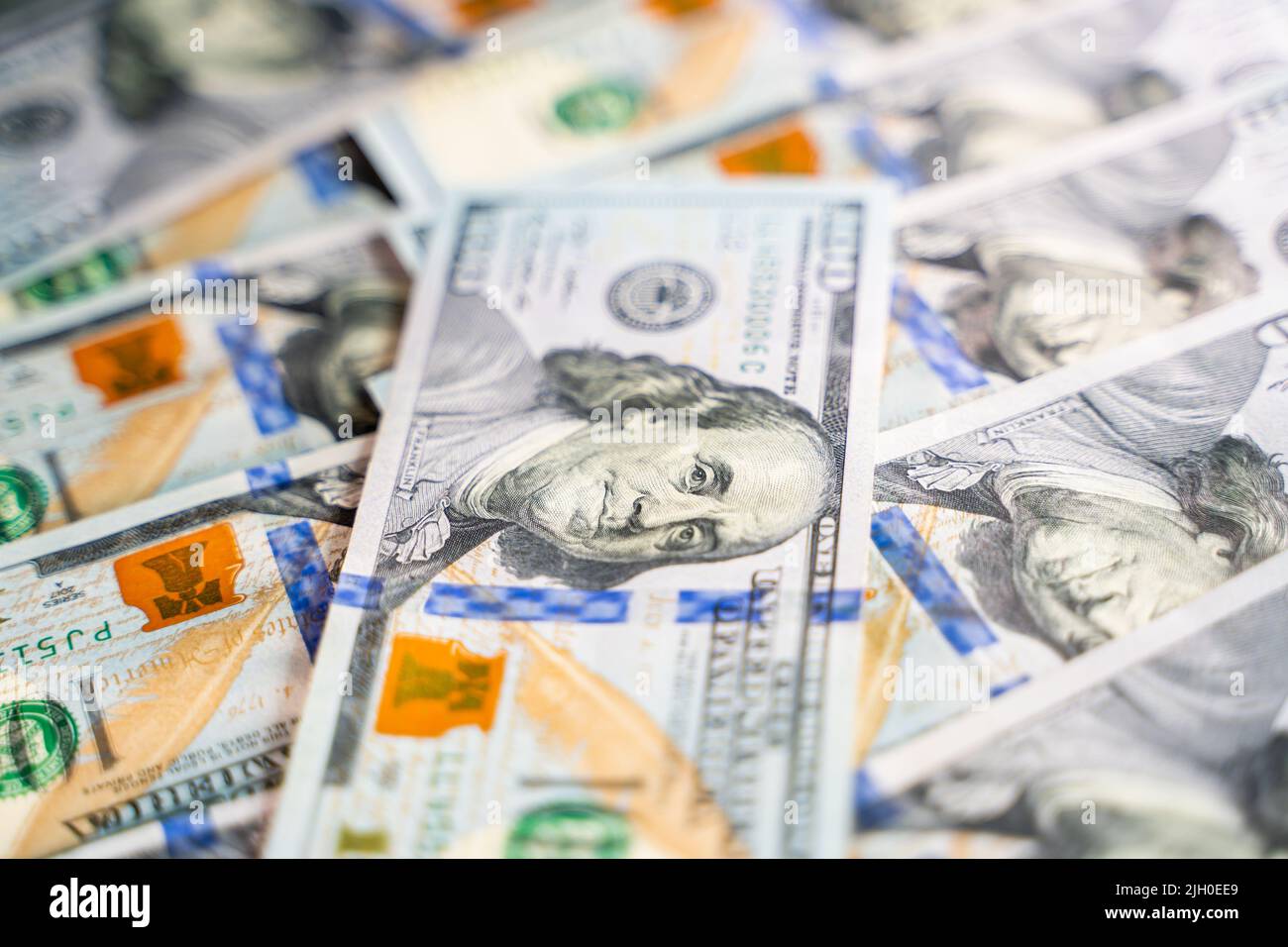 Close-up beautiful clean new one hundred dollar bill lies on other one ...