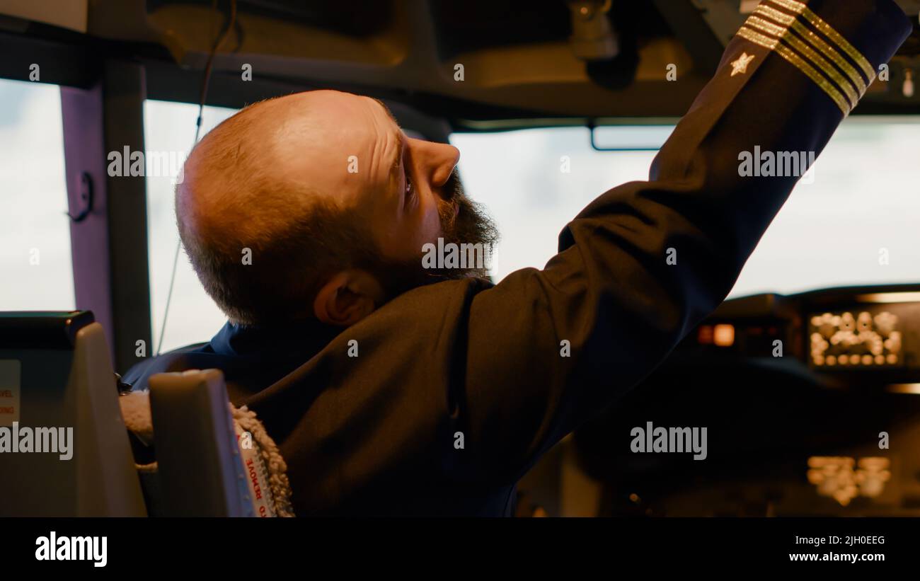 Airline captain using control panel buttons command to fly plane from ...