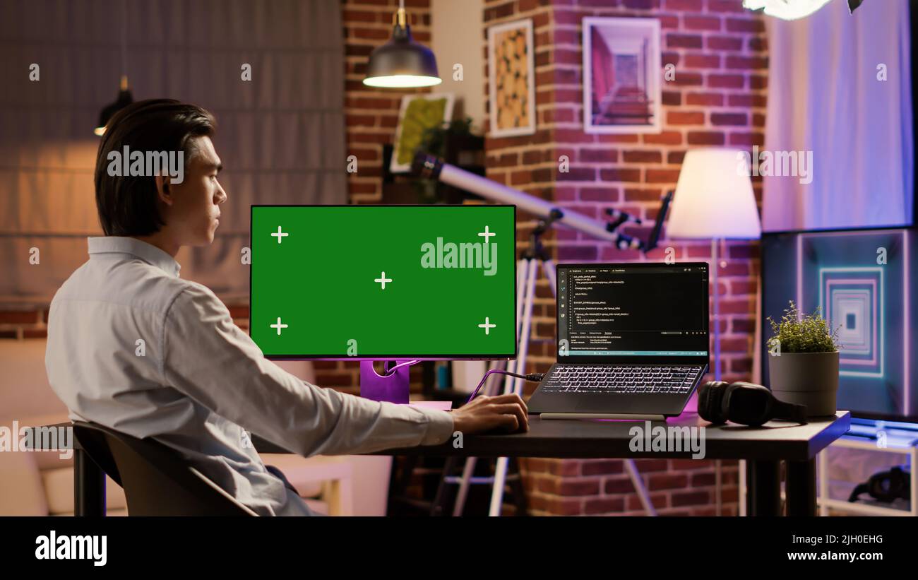 Office Employee Analyzing Greenscreen On Computer Monitor At Home Desk Using Blank Chroma Key