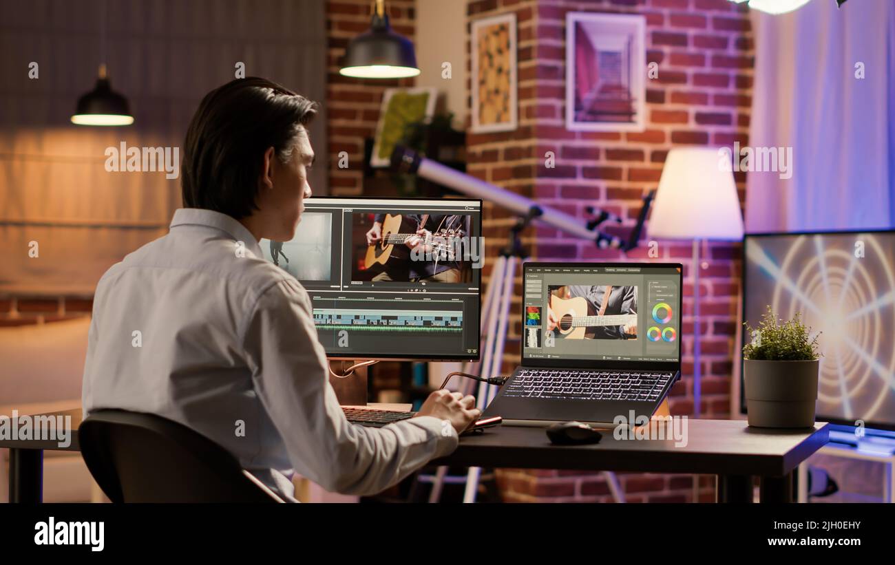 Media freelancer using film production software on computer to edit ...