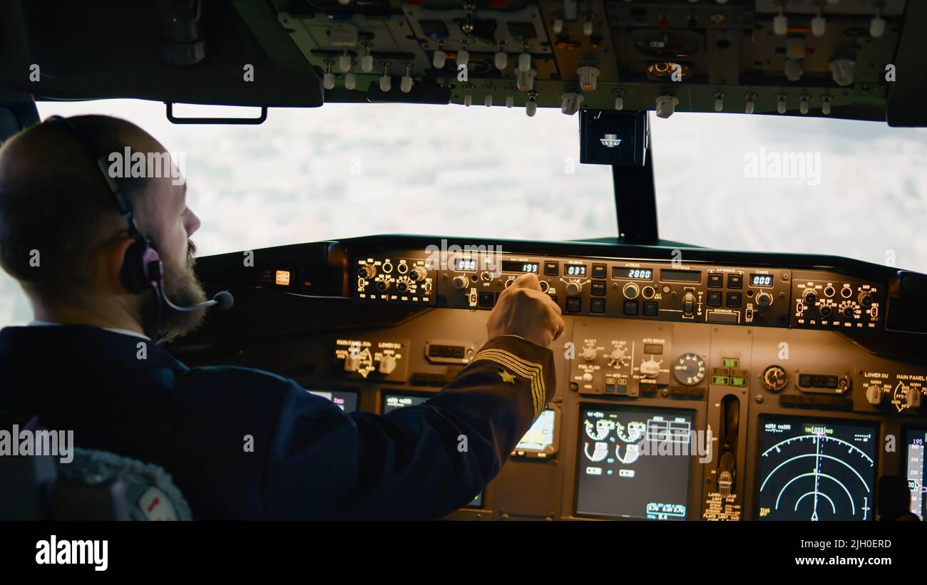 Airplane pilot flying aircraft fixing altitude and longitude level ...