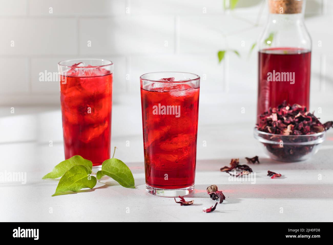 A refreshing drink made of dried hibiscus leaves and ice in a glass ...