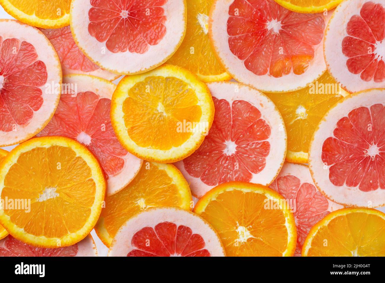 Round slices of citrus fruits top view. Citrus fruits orange and ...