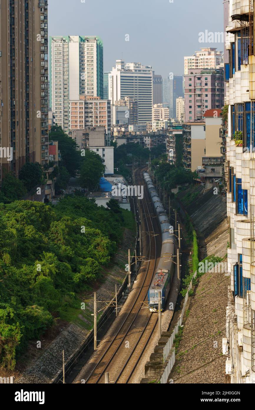 A train crossing the buildings on either side at Guangzhou Stock Photo ...