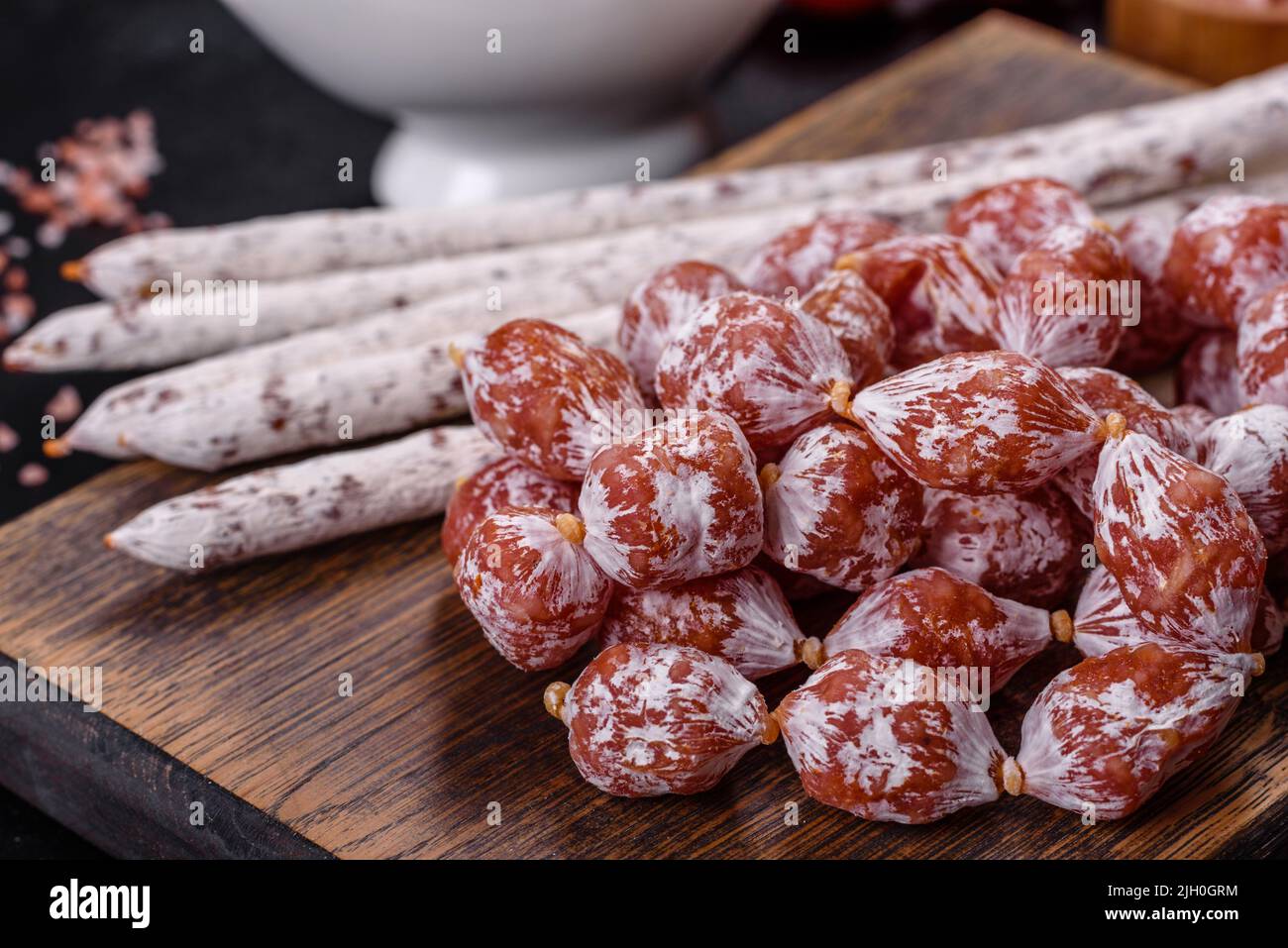 Spanish Fuet sausage slices, on a dark concrete background Stock Photo ...