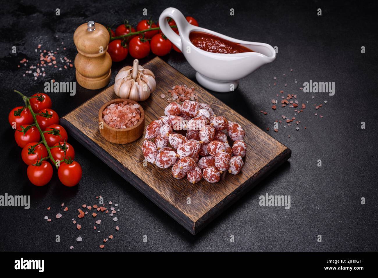 Spanish Fuet sausage slices, on a dark concrete background Stock Photo ...