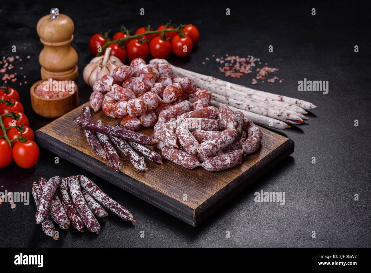 Spanish Fuet sausage slices, on a dark concrete background Stock Photo ...
