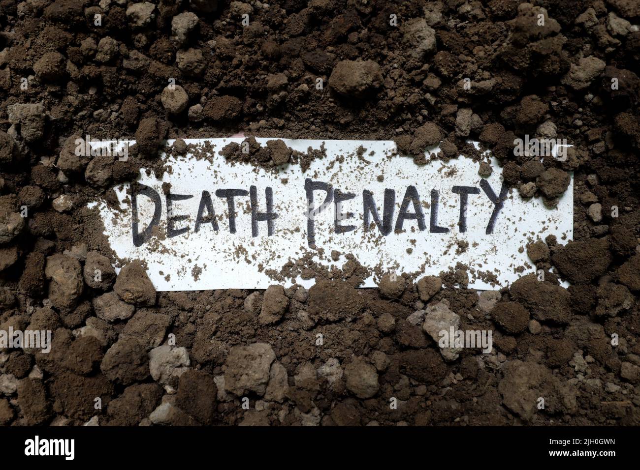 Death penalty concept. Written word on paper under soil Stock Photo - Alamy