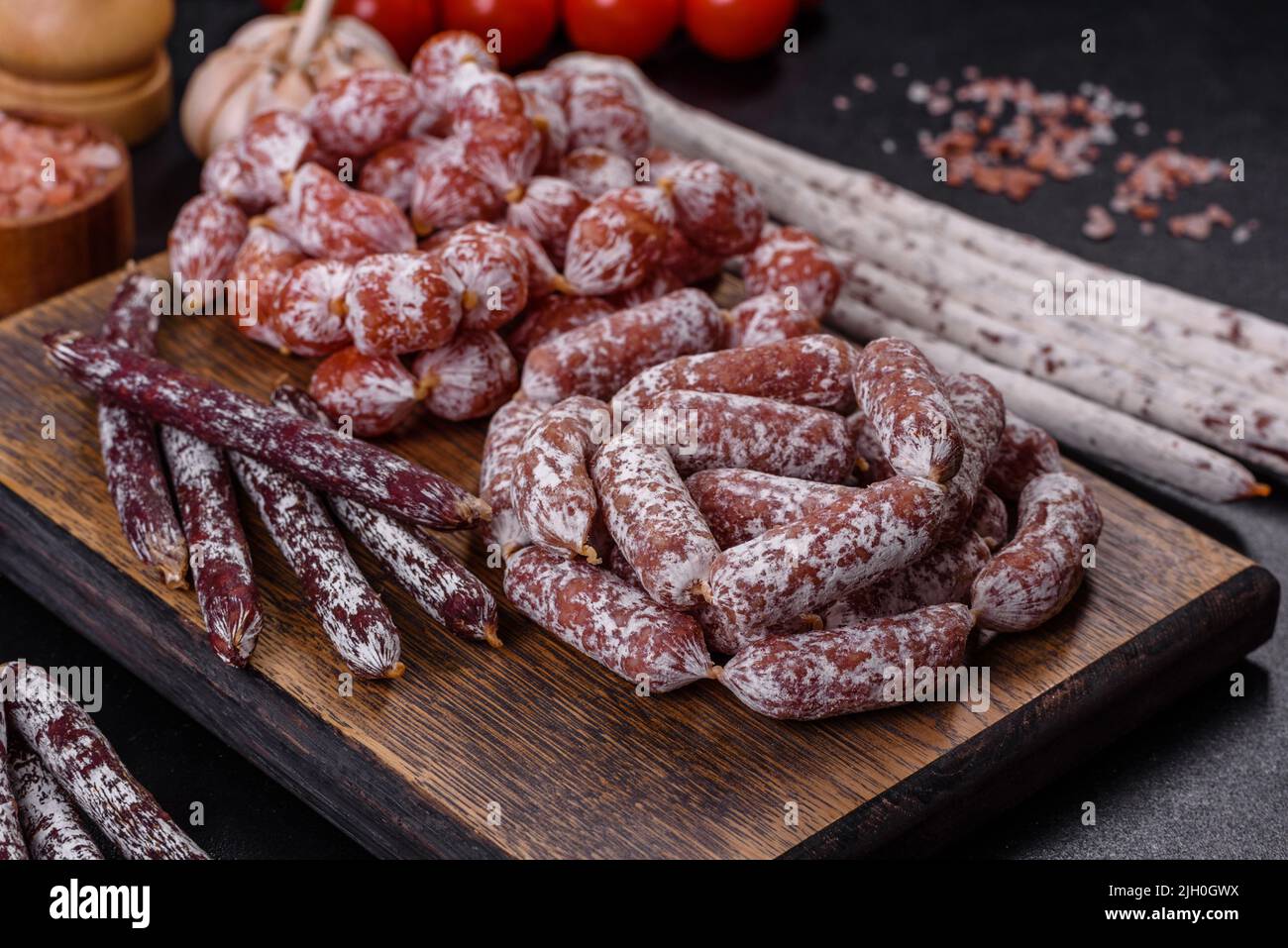 Spanish Fuet sausage slices, on a dark concrete background Stock Photo ...