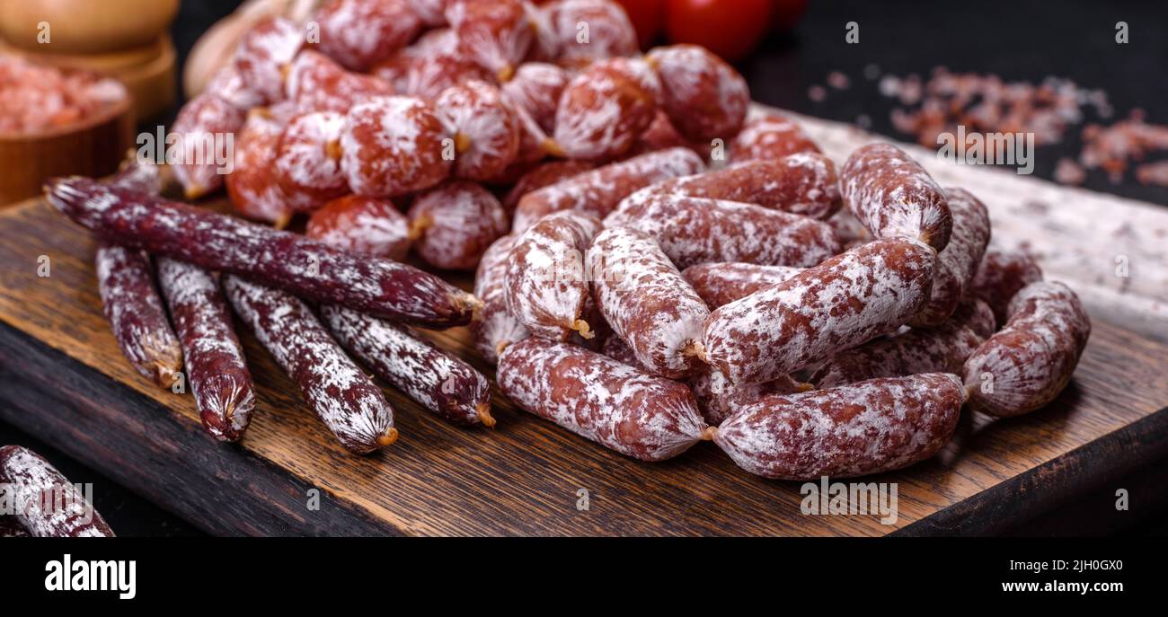 Spanish Fuet sausage slices, on a dark concrete background Stock Photo ...