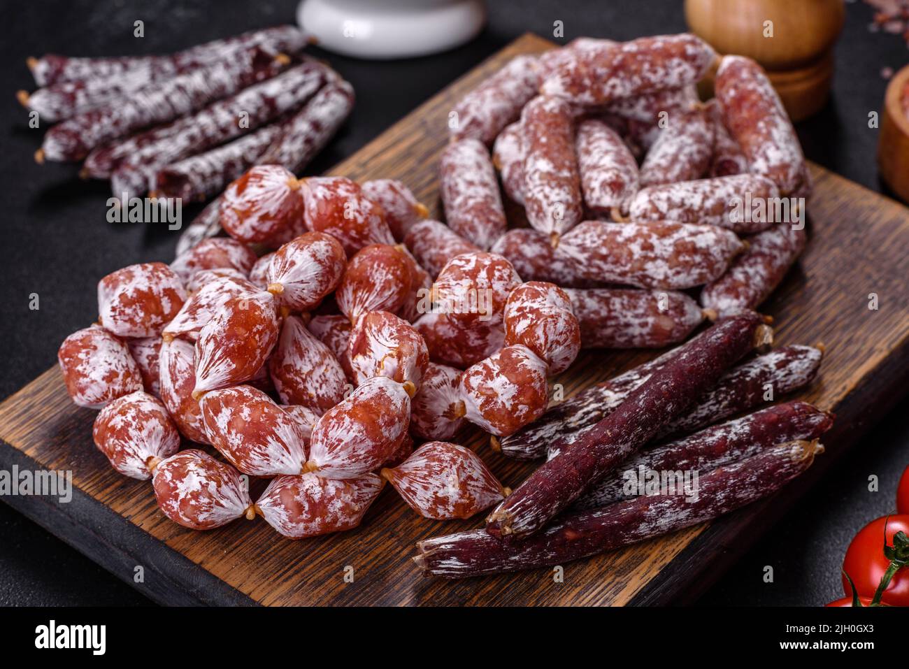 Spanish Fuet sausage slices, on a dark concrete background Stock Photo ...