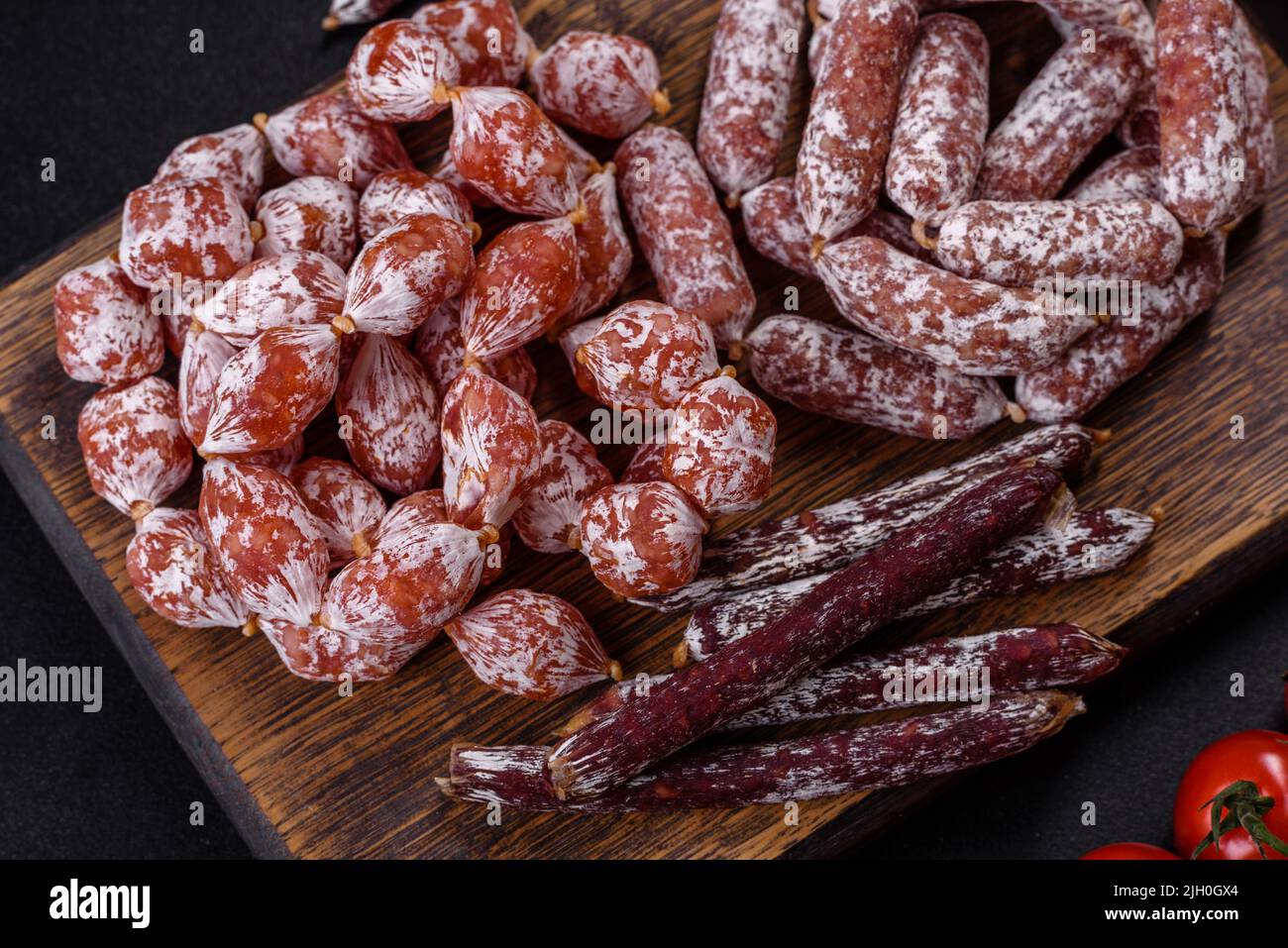 Spanish Fuet sausage slices, on a dark concrete background Stock Photo ...