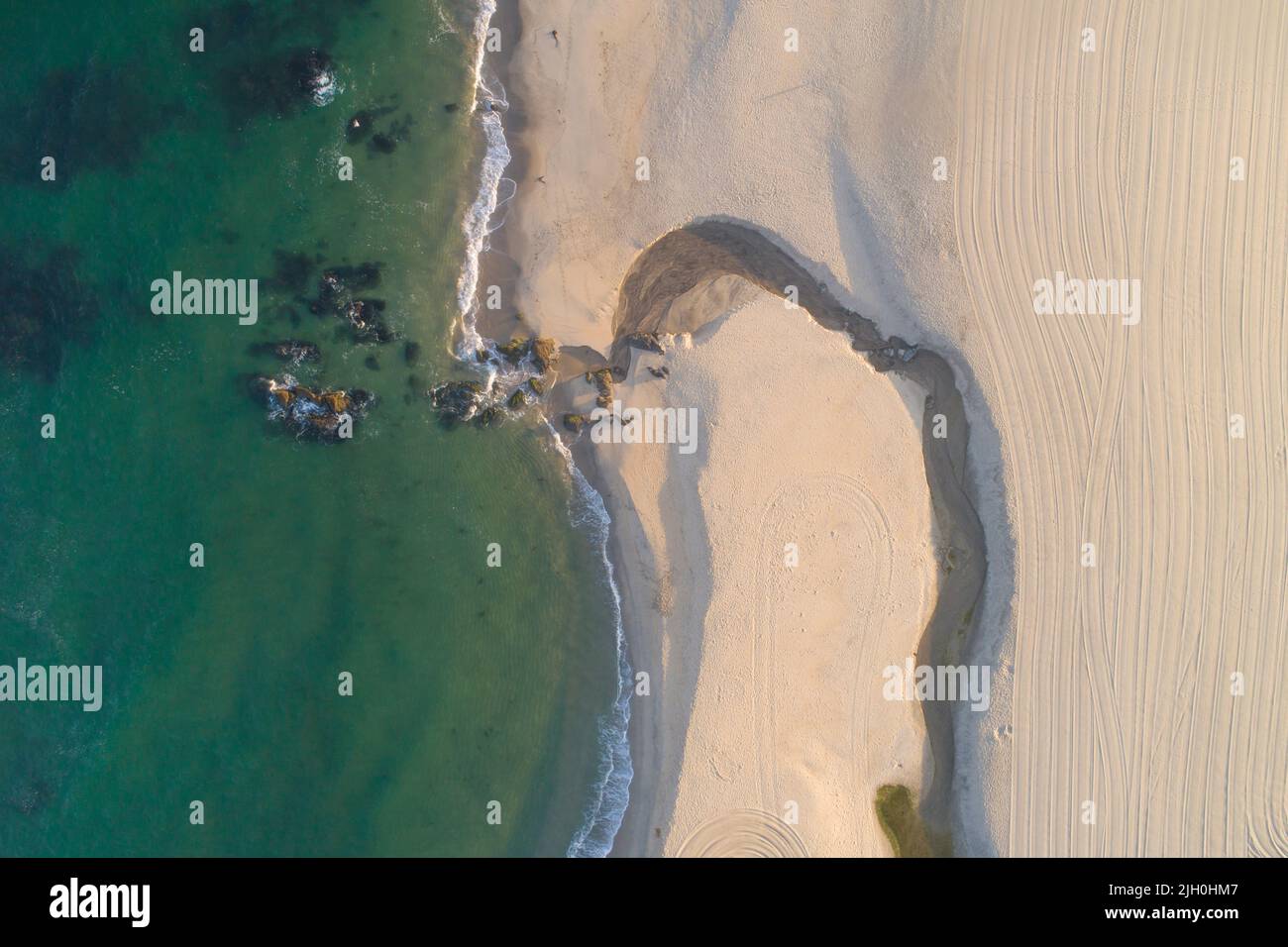 Zenithal aerial view at dawn of the mouth of a creek on a beach Stock ...