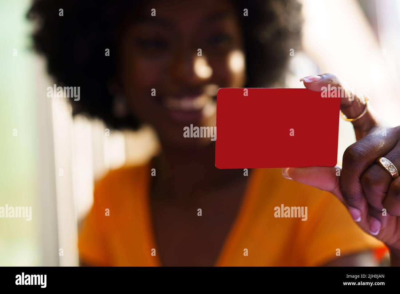 Portrait of young american woman with afro hairstyle holding red ...