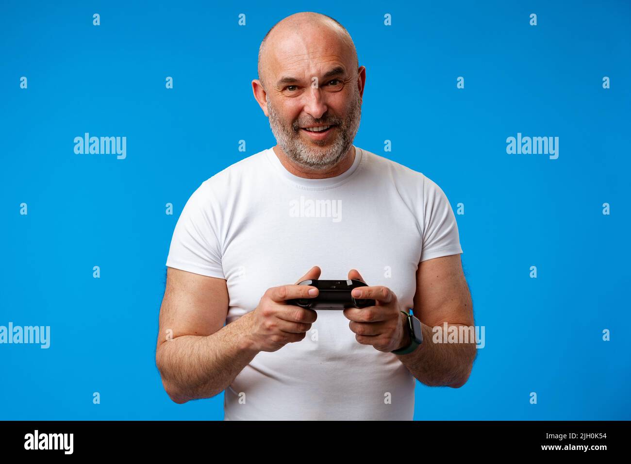 Portrait of middle-aged man playing videogames with joystick against ...