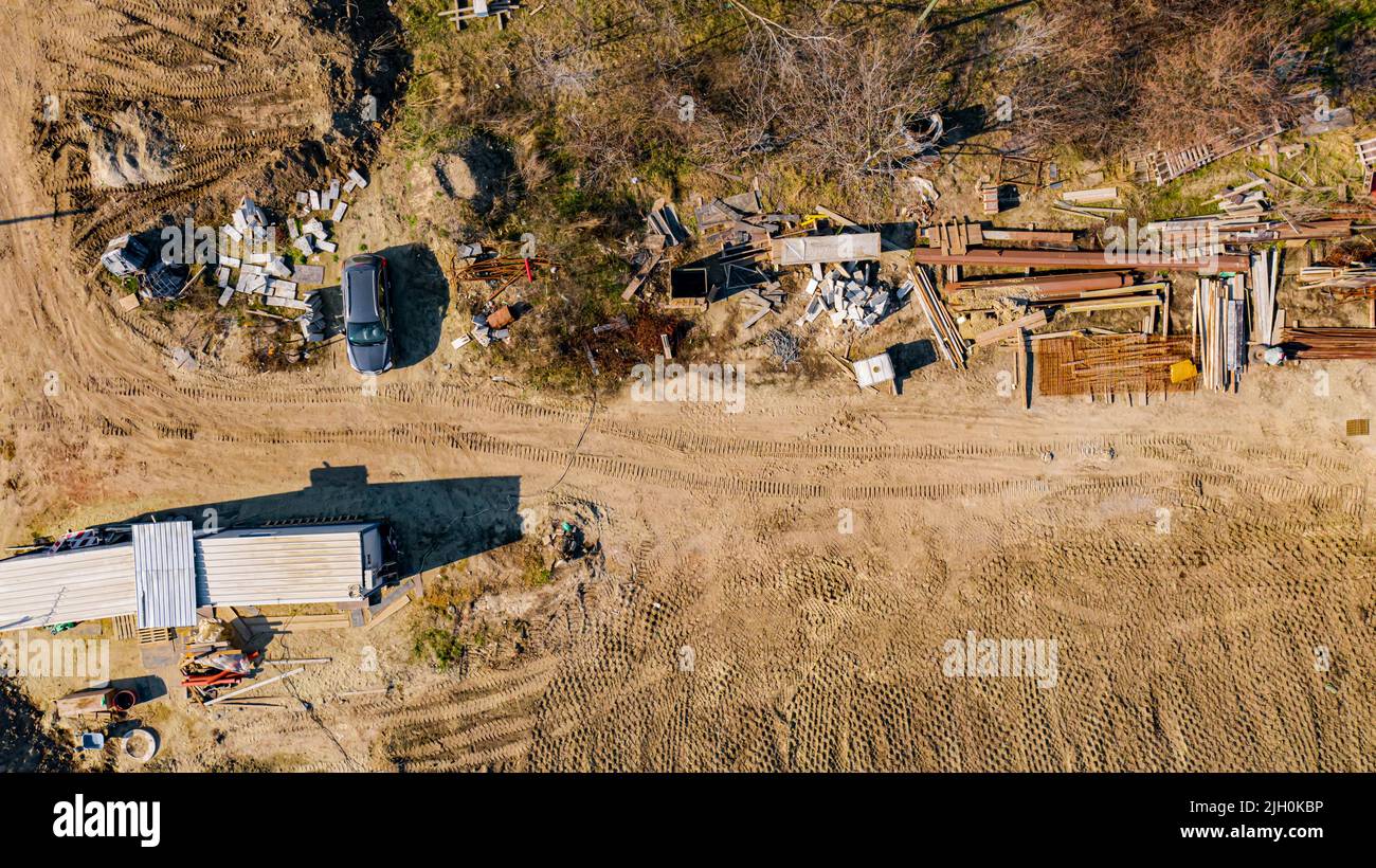 Above top view on alfresco improvised warehouse with parts of ...