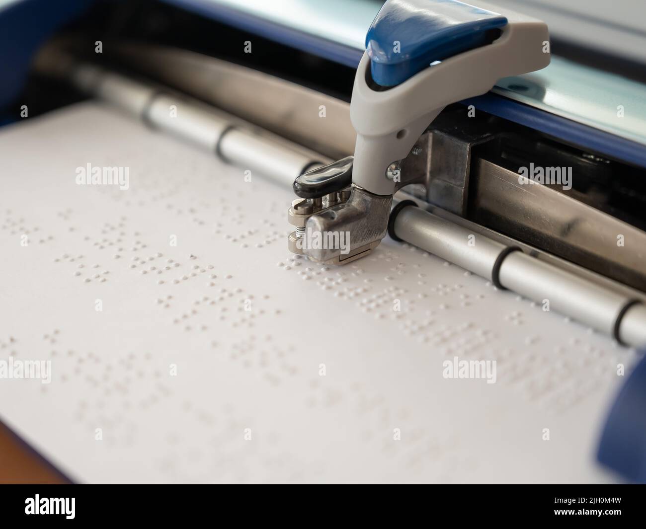 Close-up of a braille code printing machine Stock Photo - Alamy