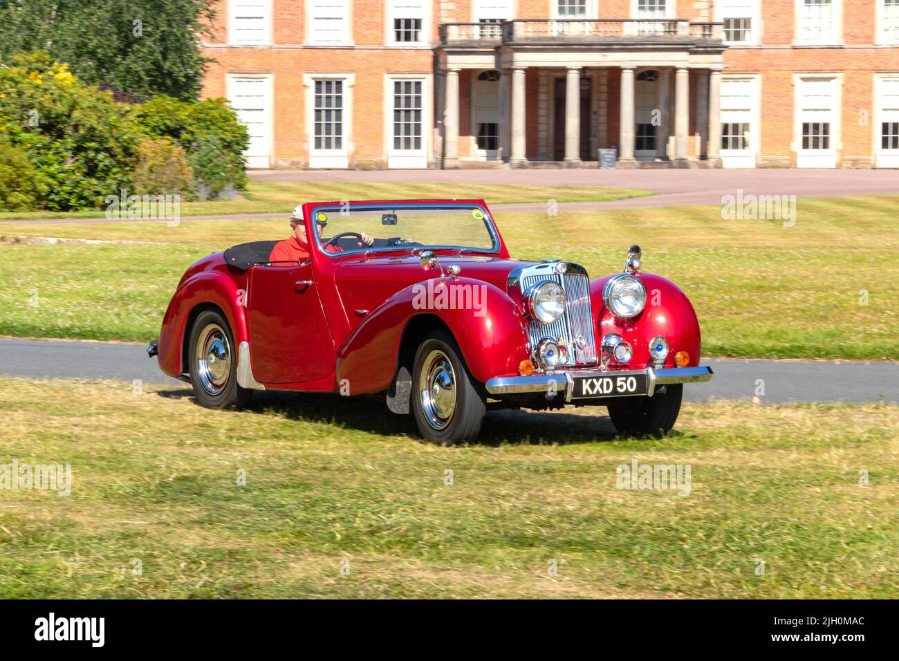classic vintage 1949 red Triumph Roadster KXD 50 in front of stately ...