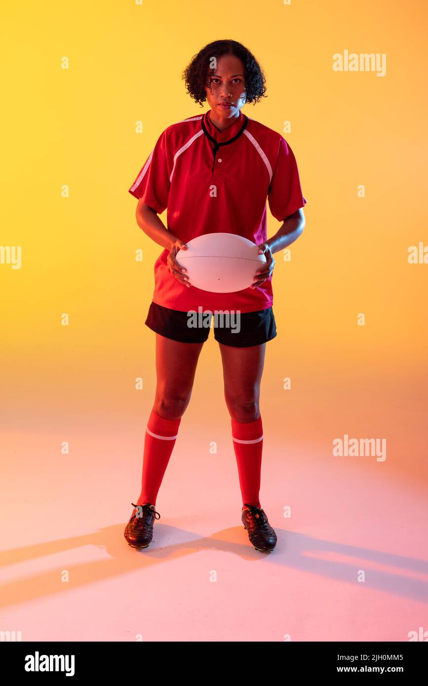Portrait of african american female rugby player with rugby ball over ...