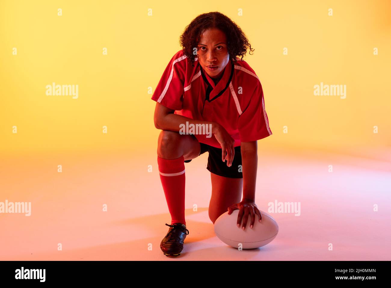 Portrait of african american female rugby player with rugby ball over ...