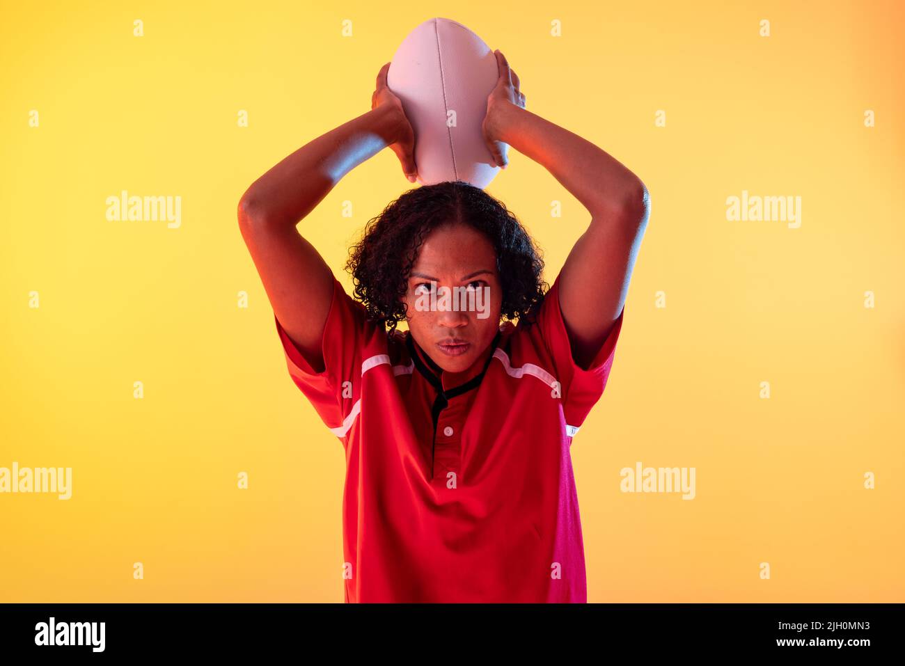 Portrait of african american female rugby player with rugby ball over ...