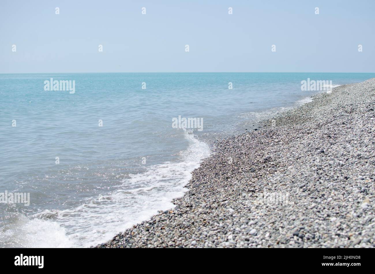 Sky, sea and sand with pebbles as a background. Natural landscape view ...
