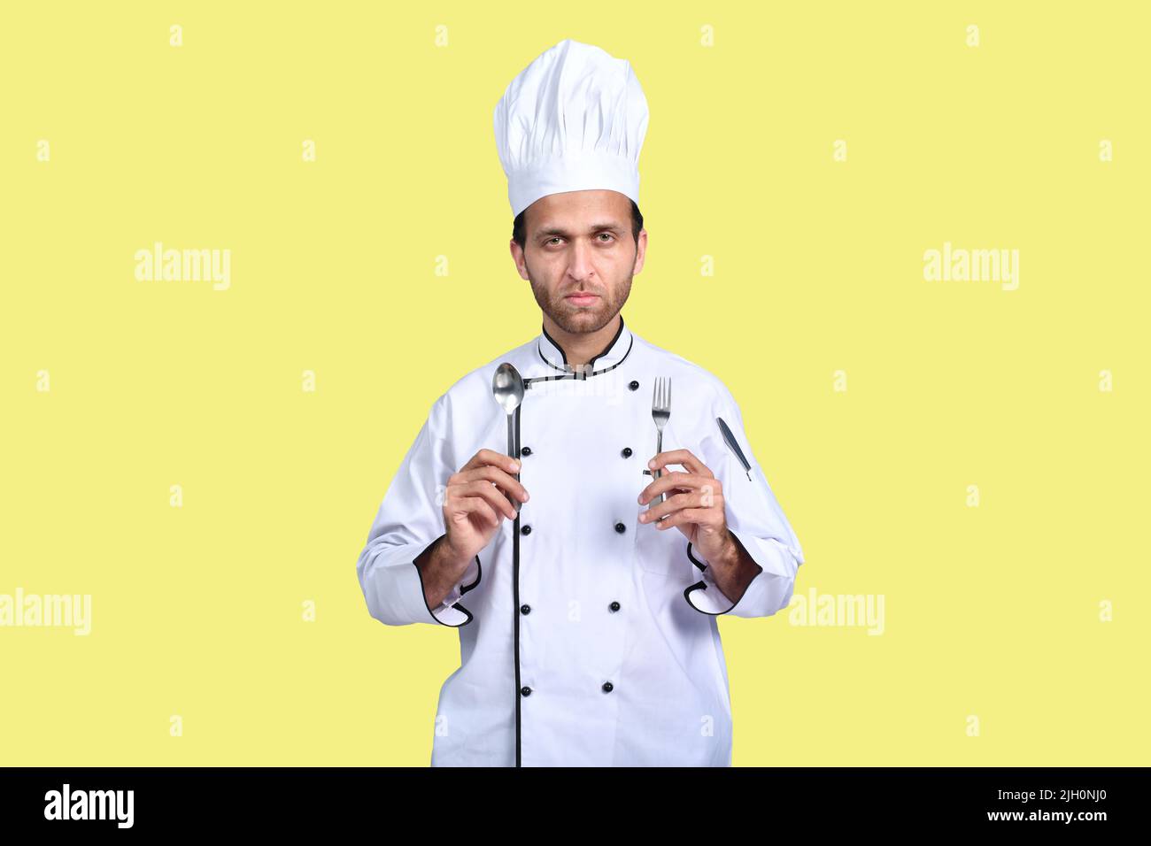 Male Chef posing front pose with fock and spoon in hand Stock Photo - Alamy