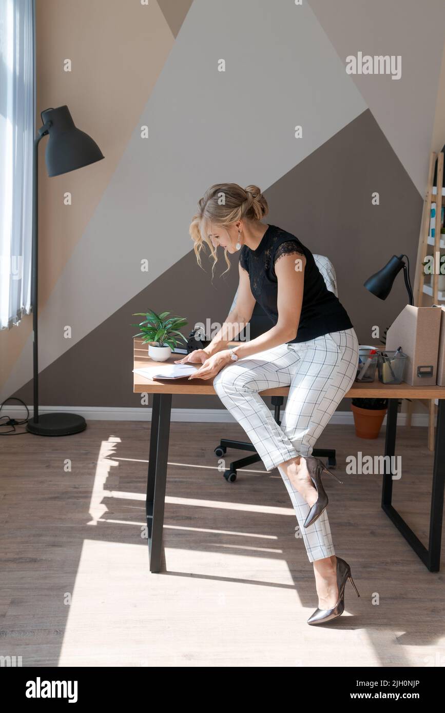 Pensive female administrative assistant. Reading information report in ...