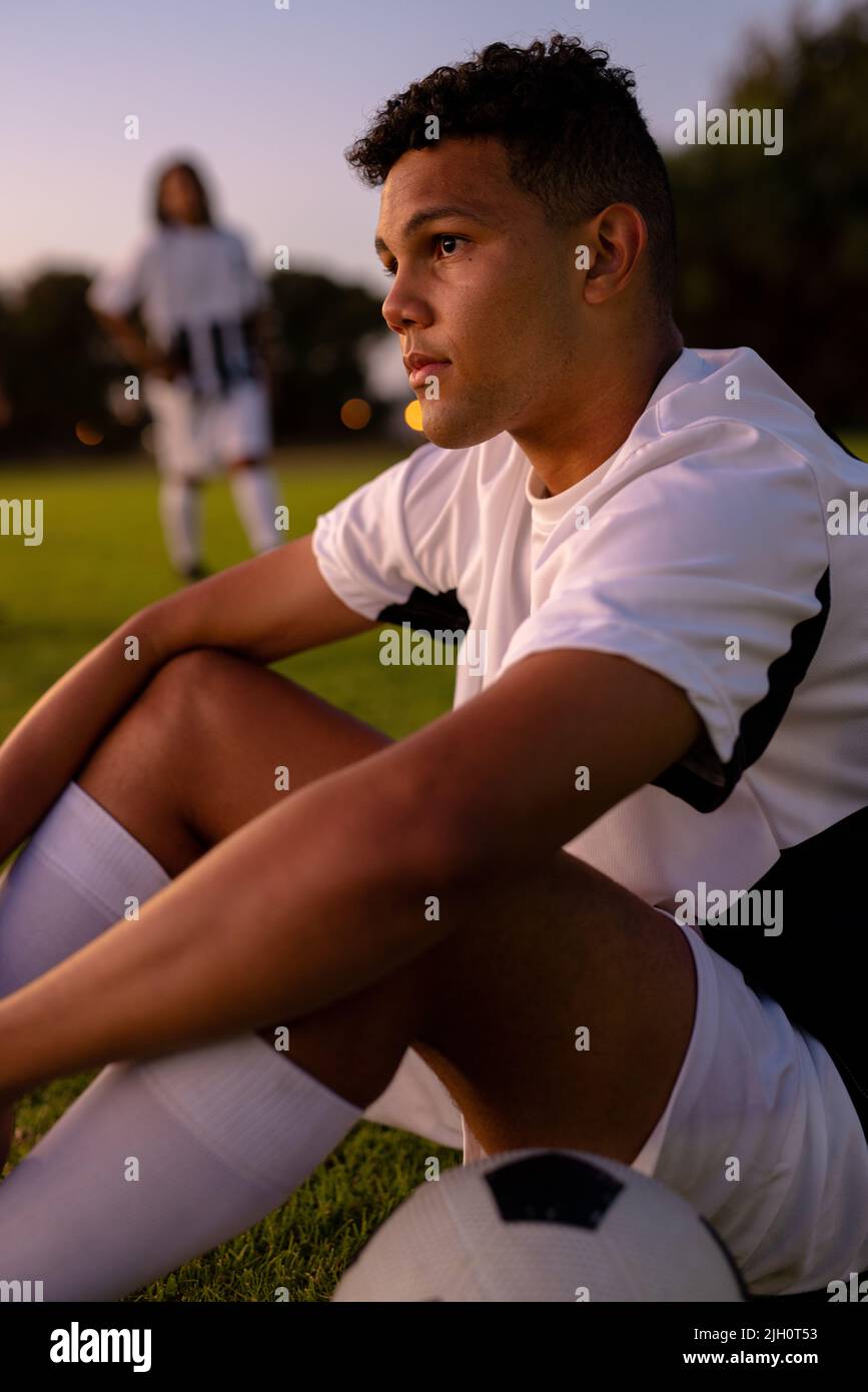 Side view of thoughtful sad caucasian male player looking away while ...