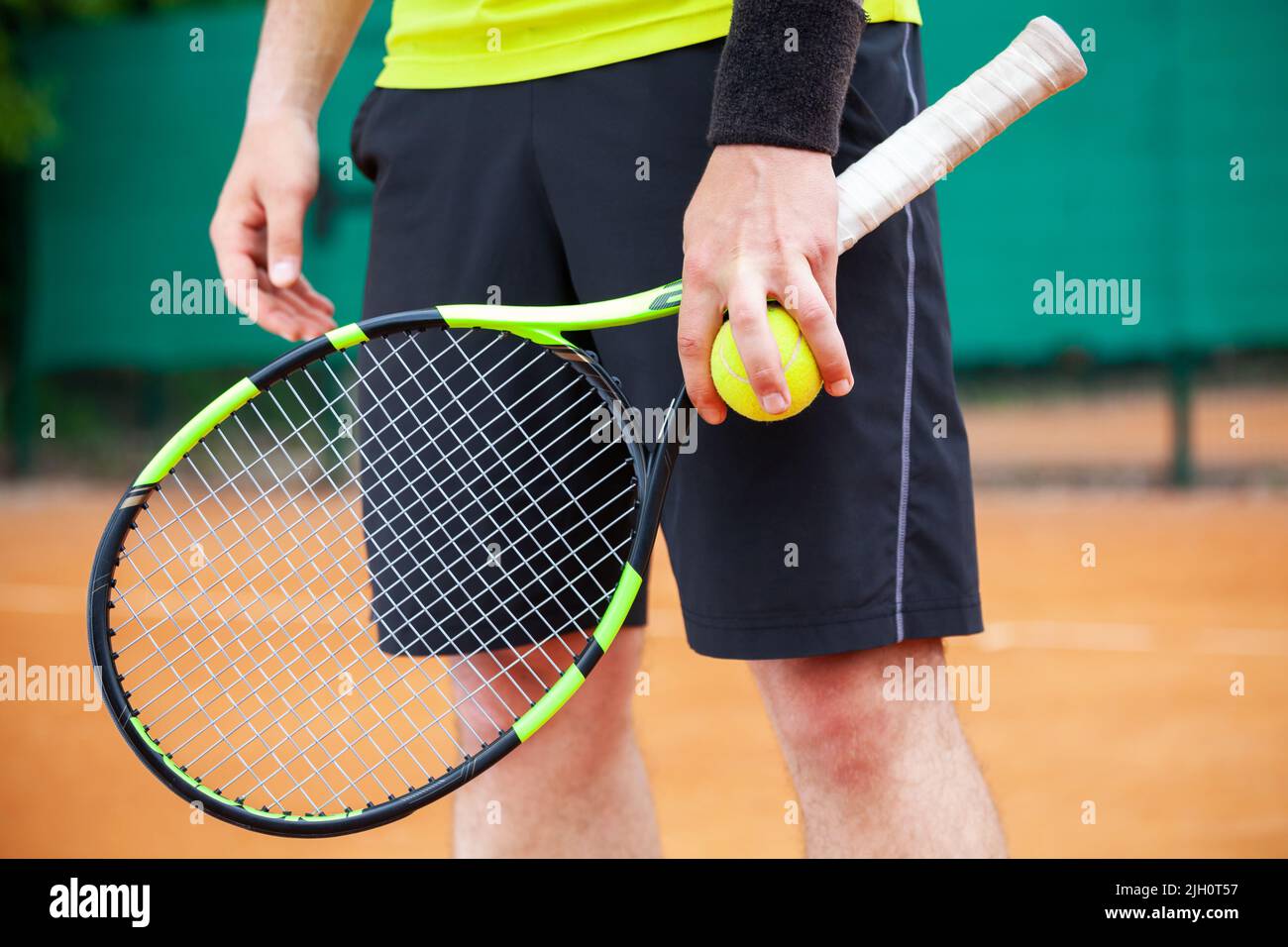 Close up male tennis player holding racket and ball Stock Photo - Alamy
