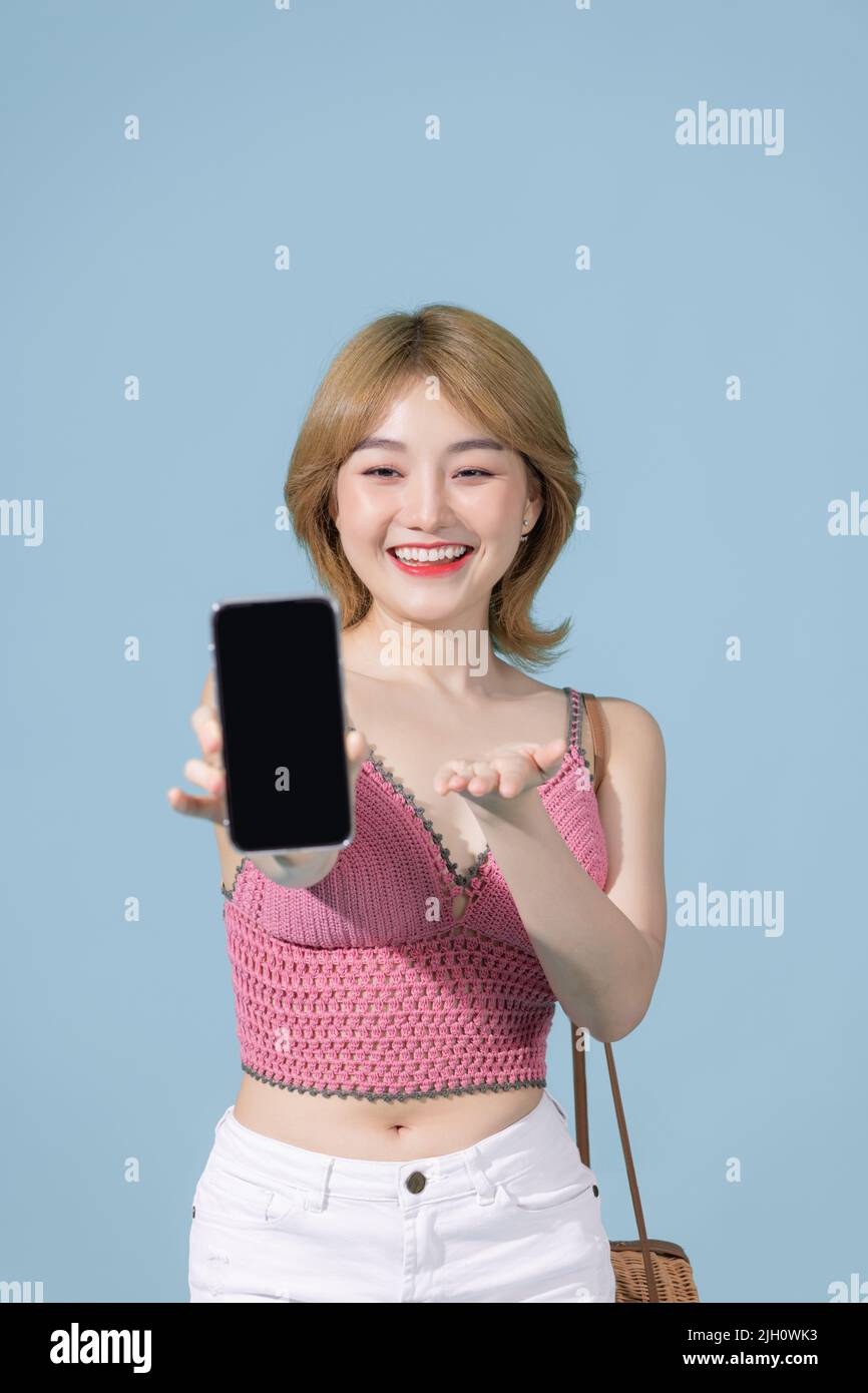 Charming adorable young beautiful asian woman wearing pink top holding ...