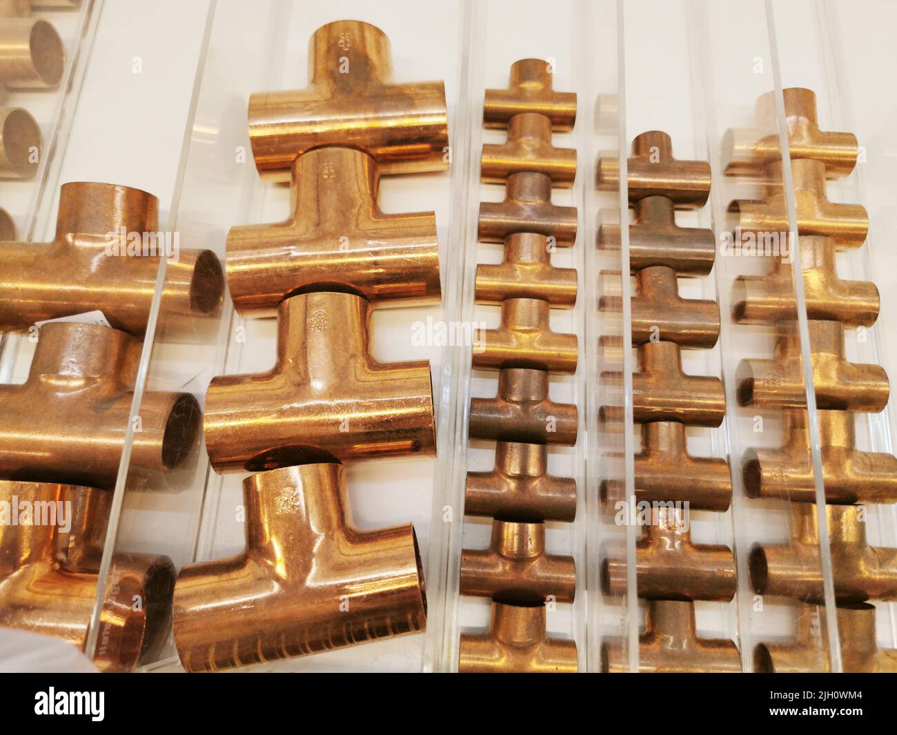 Copper pipe fittings in a shop Stock Photo - Alamy