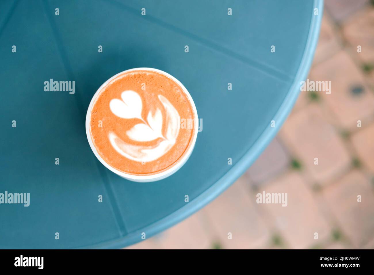 Cappuccino with frothy foam, coffee cup top view is on the plastic ...