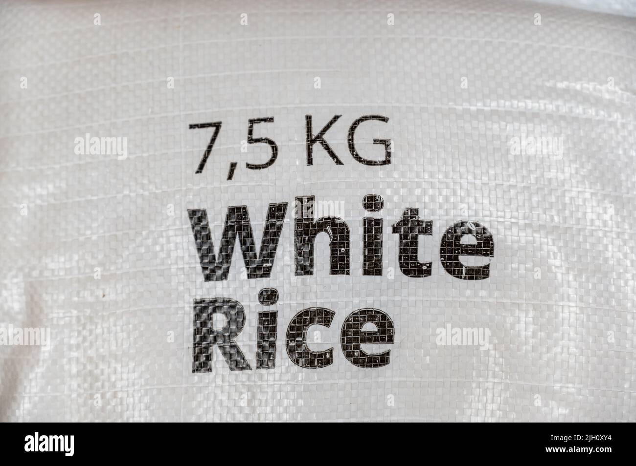 Bag of white rice. The black lettering on the white bag indicates the ...