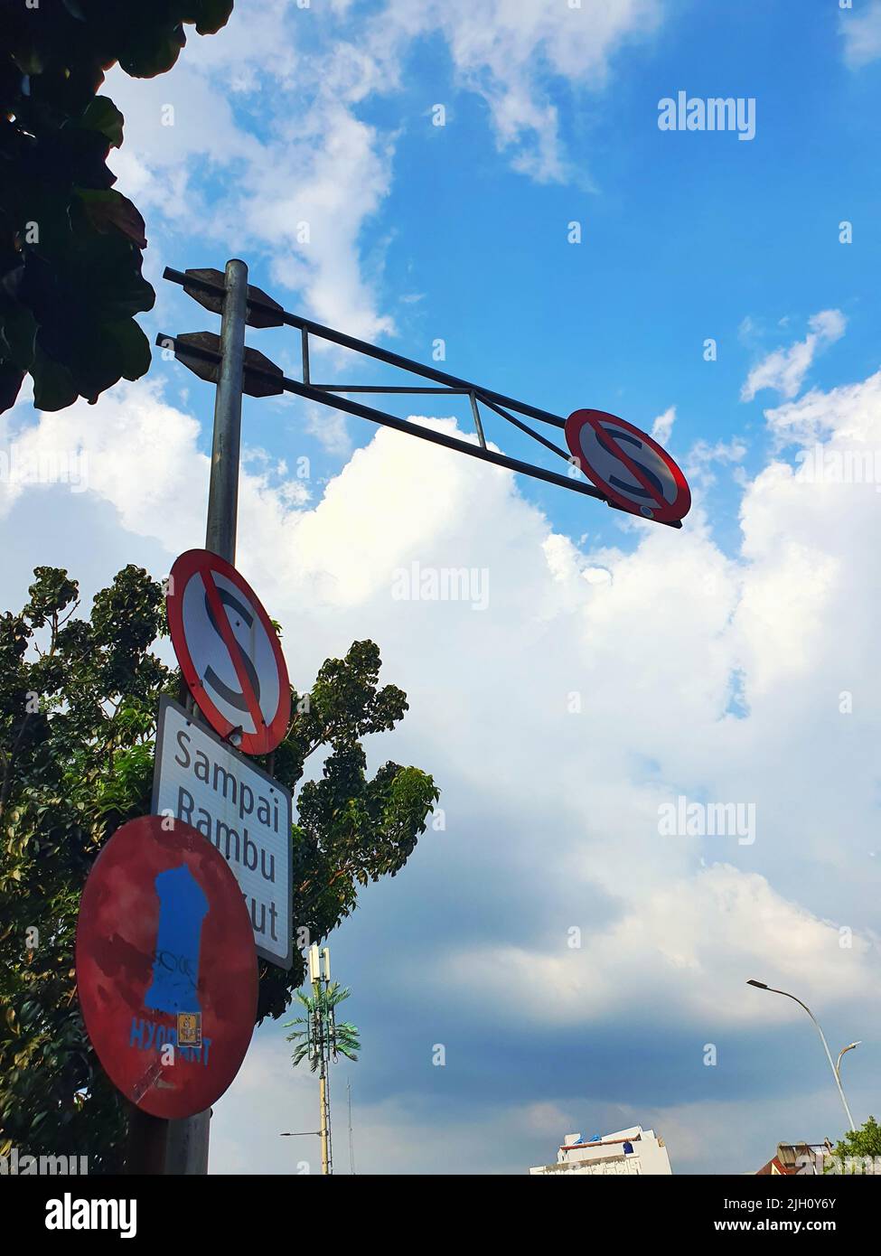 The road sign prohibits stopping against the background of sky. Close ...