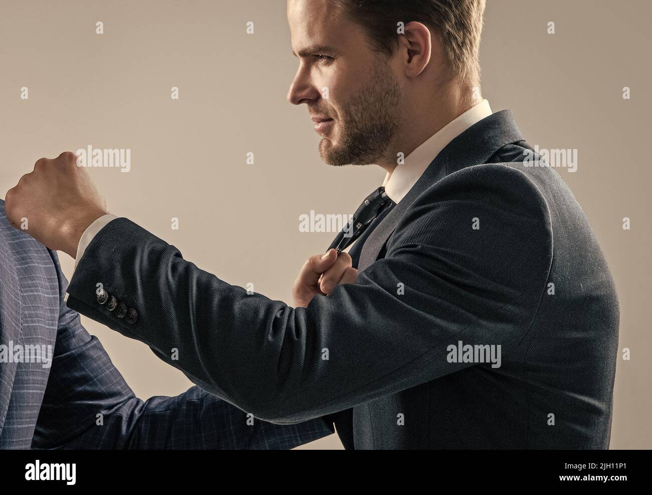 Manager have fist fight with male adult in formal wear grey background ...
