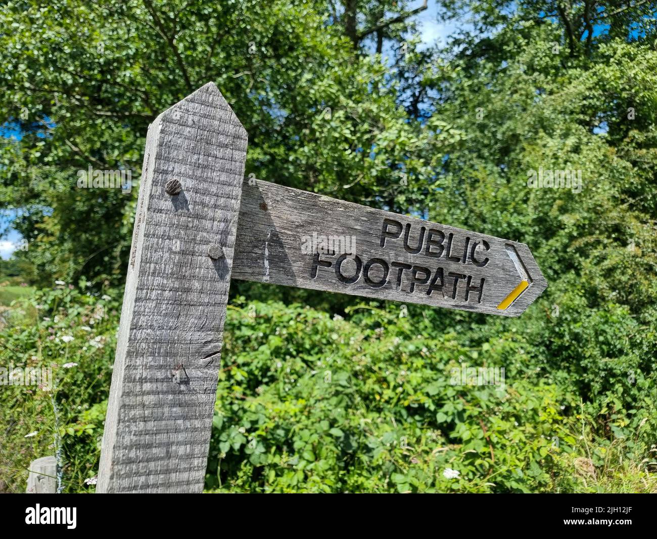 A public foot path sign showing the route of a hiking trail in England ...