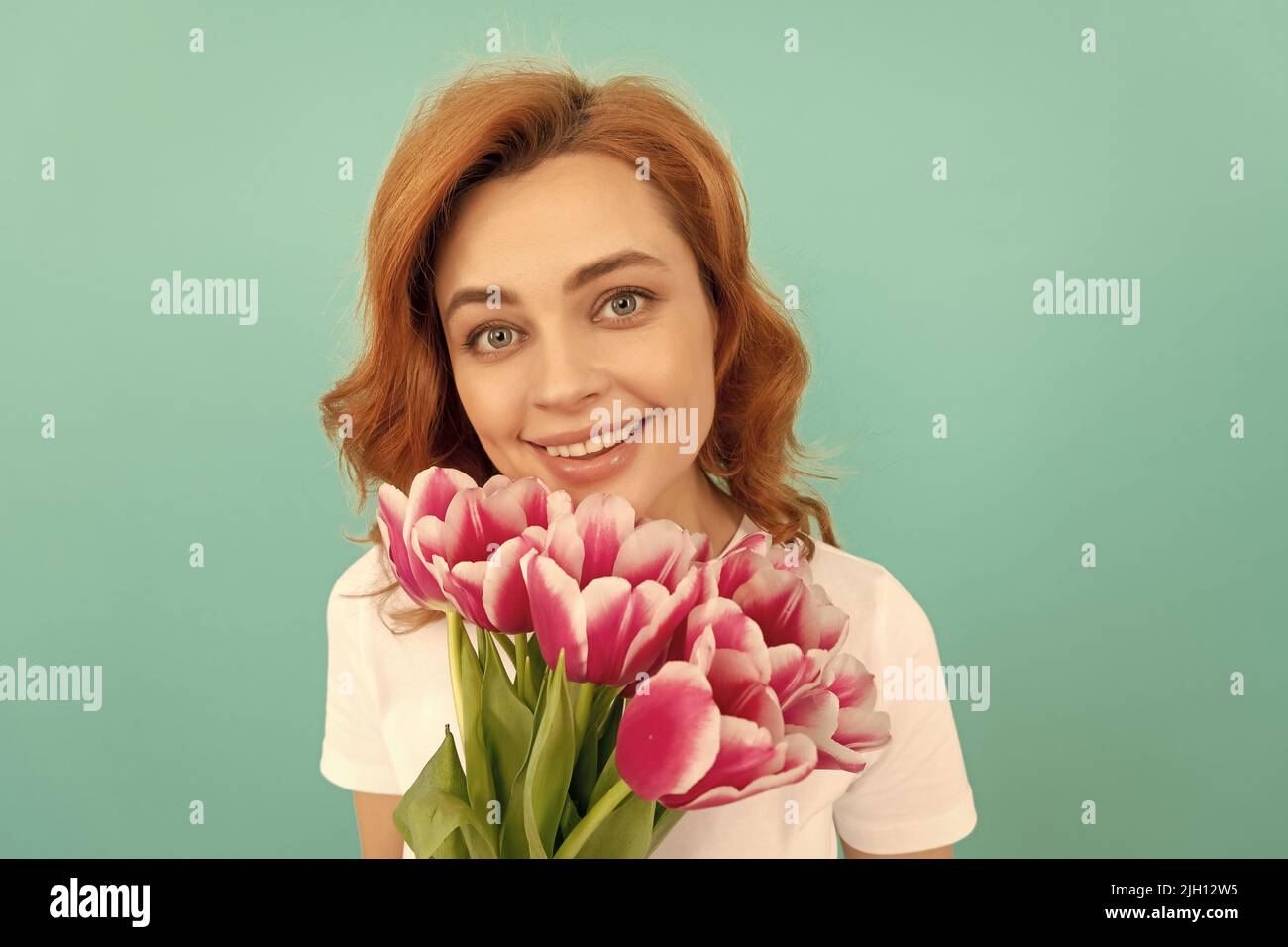 happy woman face with tulip flower bouquet on blue background Stock ...