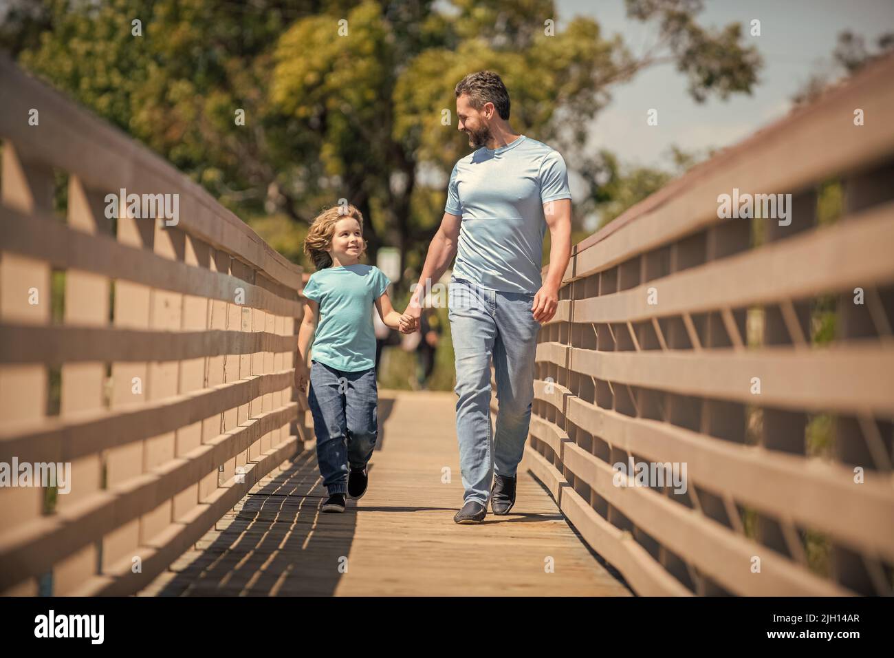 cheerful father walking with his son outdoor, friendship Stock Photo ...