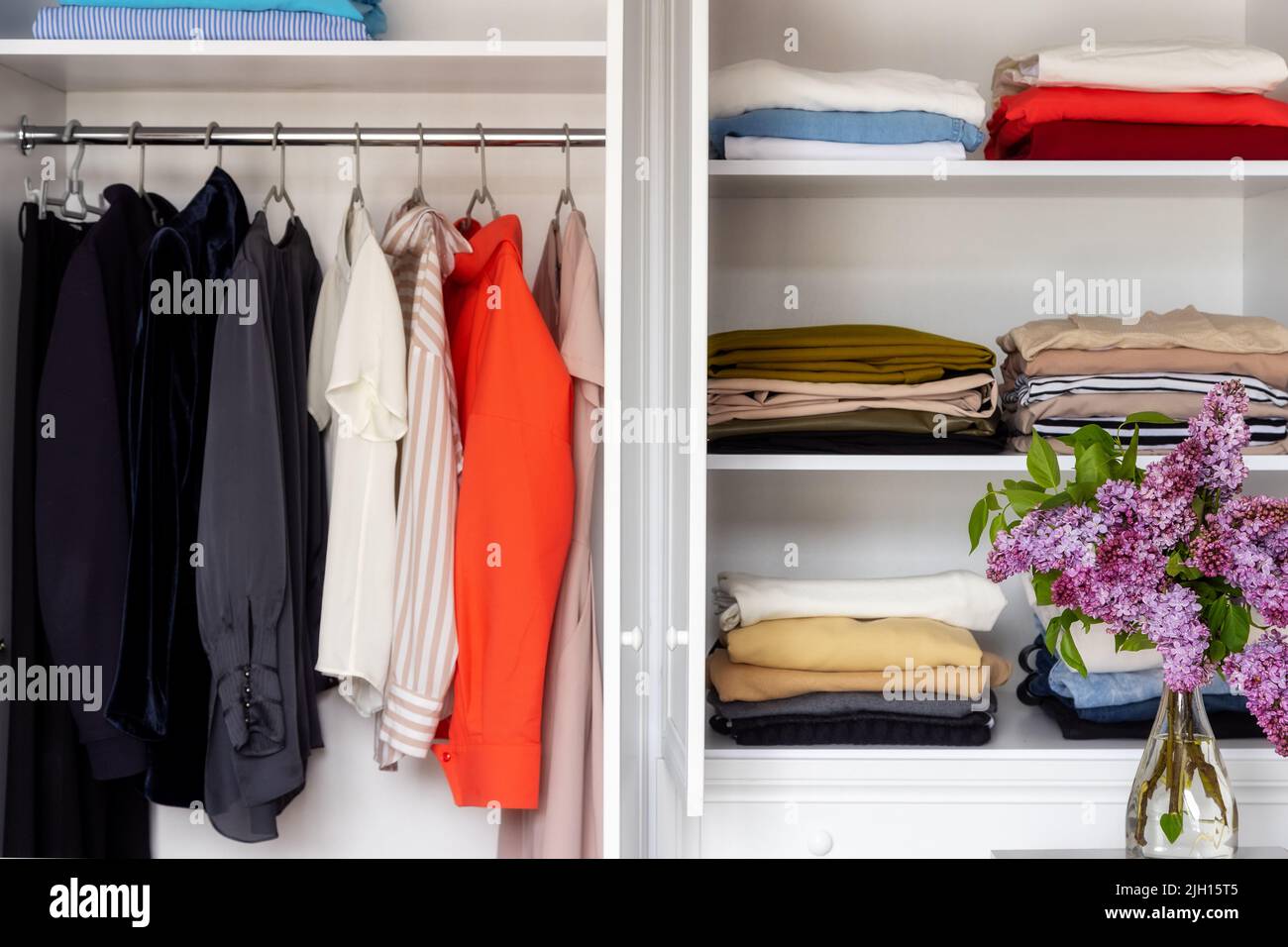 Modern wardrobe with stylish spring clothes and accessories Stock Photo ...