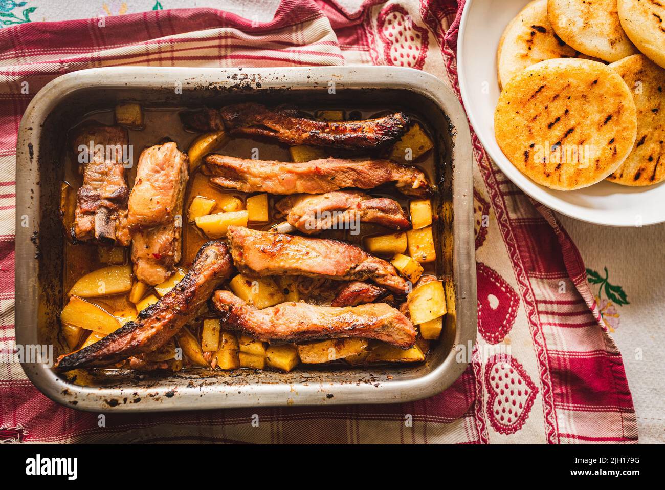grilled pork ribs on table inside oven aluminum container with ...