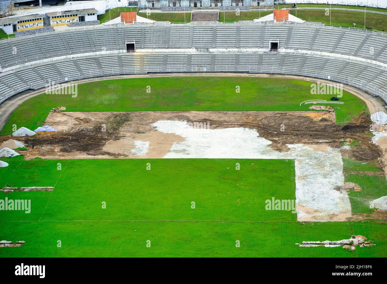 An aerial shot of large empty stadium with empty seats and destroyed ...