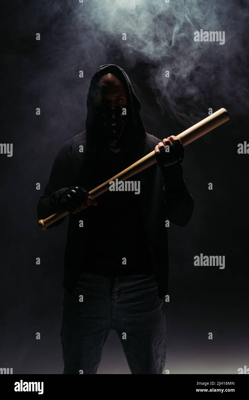 Silhouette of african american bandit with mask on face holding ...