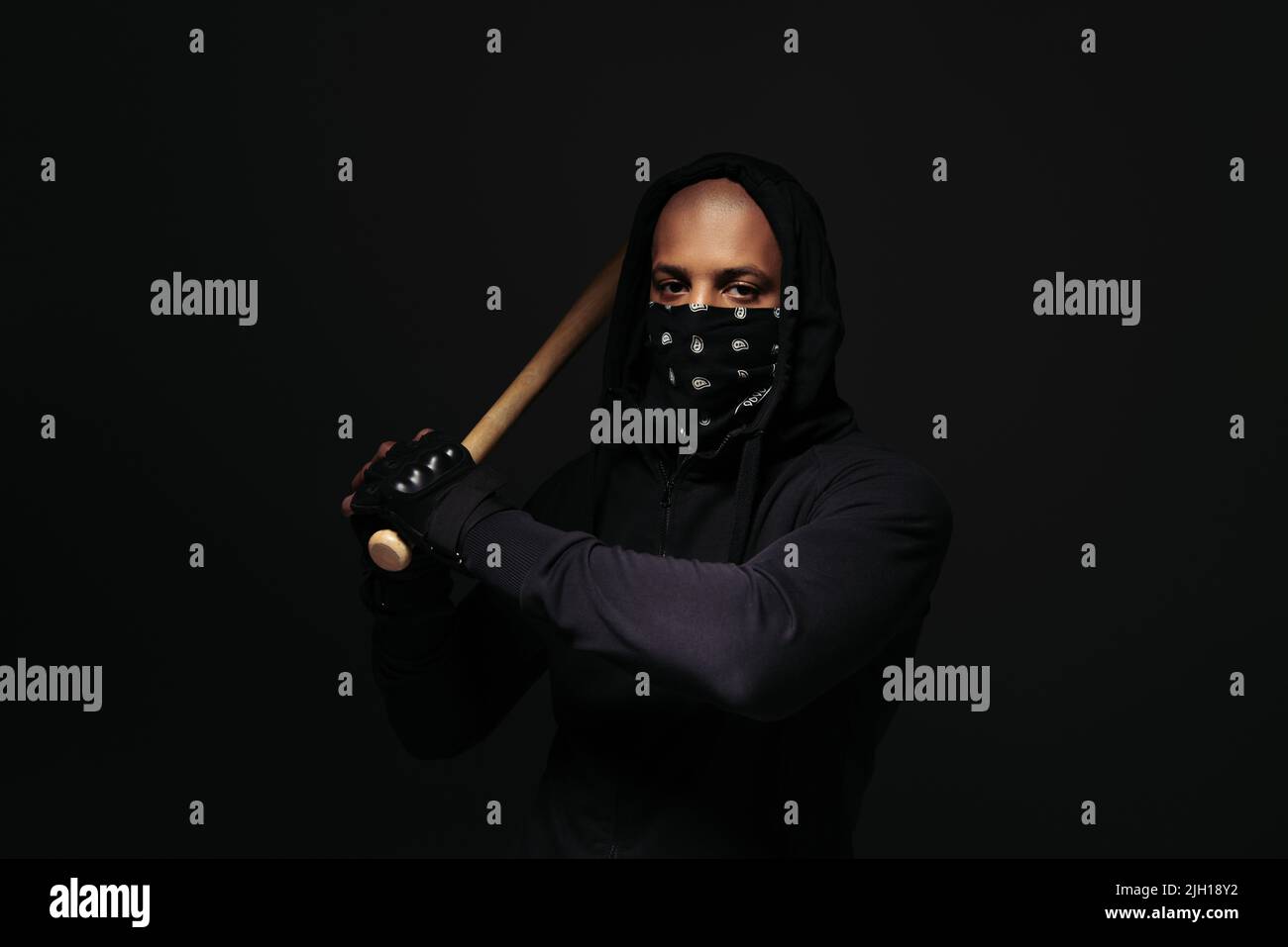 African american hooligan with mask on face holding baseball bat ...