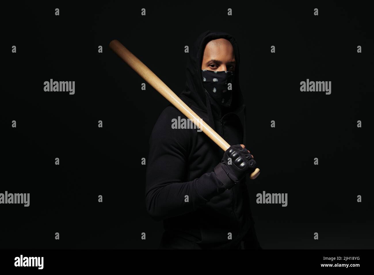 African american hooligan with mask on face holding wooden baseball bat ...