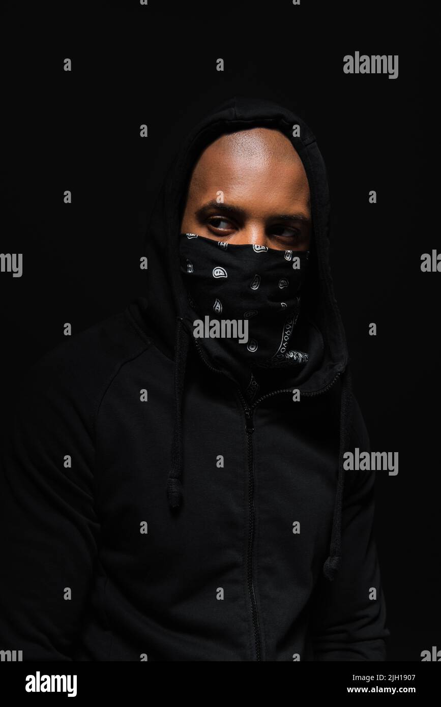 African american bandit with scarf on face looking away isolated on ...