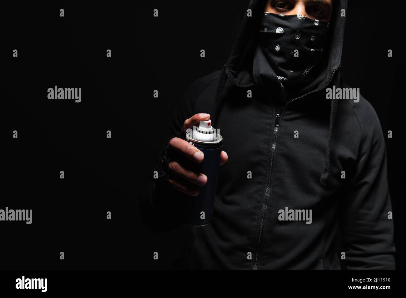 Cropped view of african american vandal with mask on face holding spray ...
